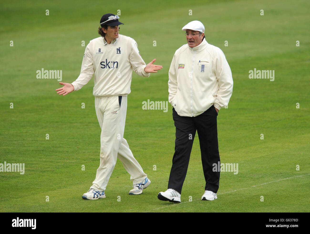 Warwickshire's Chris White (left) has a chat with umpire Nick Cook ...