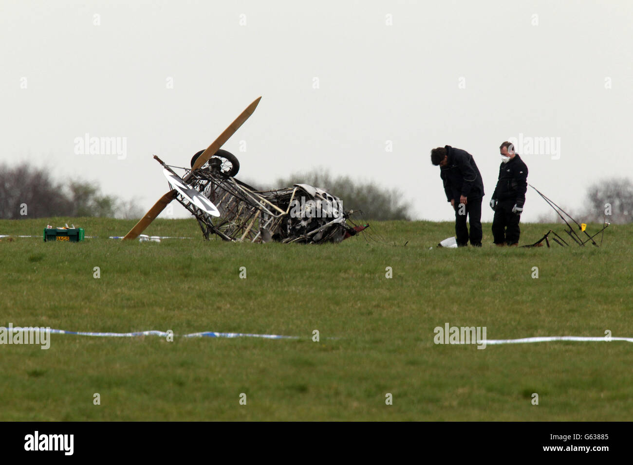 Investigators work on the wreckage of the civilian light aircraft at ...