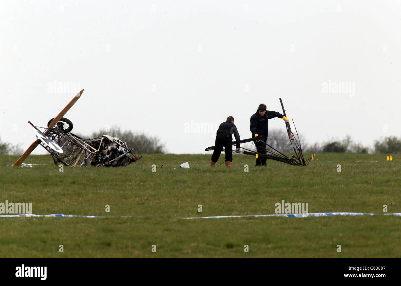 Investigators work on the wreckage of the civilian light aircraft at ...