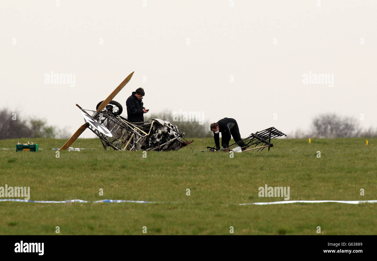 Investigators work on the wreckage of the civilian light aircraft at ...