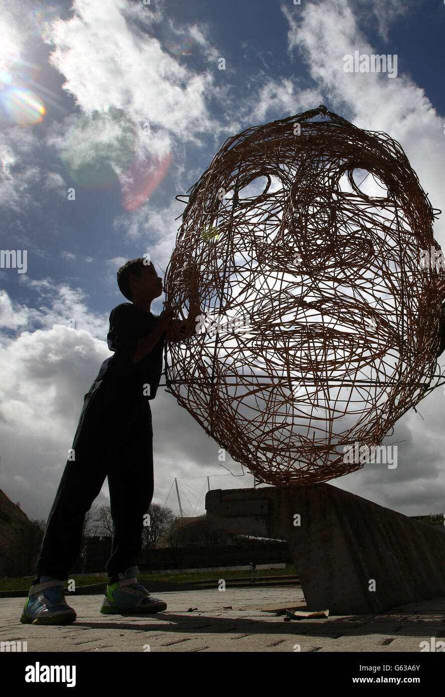 Giant face sculptures made of tree branches are hung in trees in ...