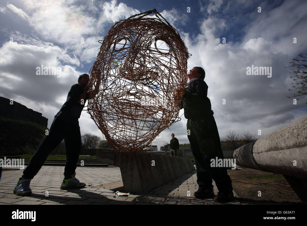 Giant face sculptures made of tree branches are hung in trees in ...