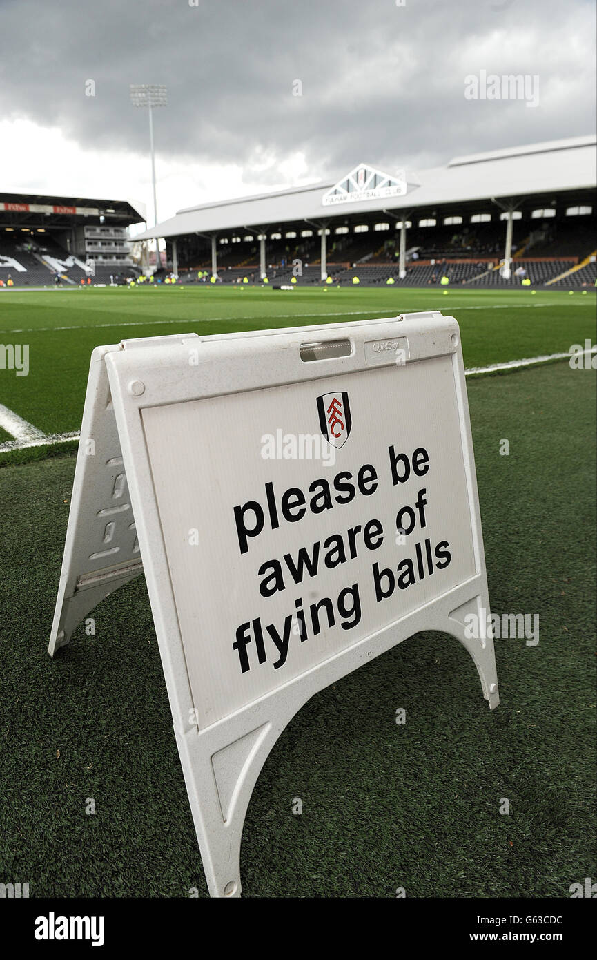 A sign warning fans of flying balls beside the Craven Cottage pitch ...
