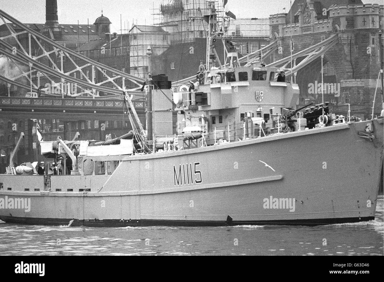 HMS Bronington, the 360-ton minesweeper, passes under the raised Tower ...