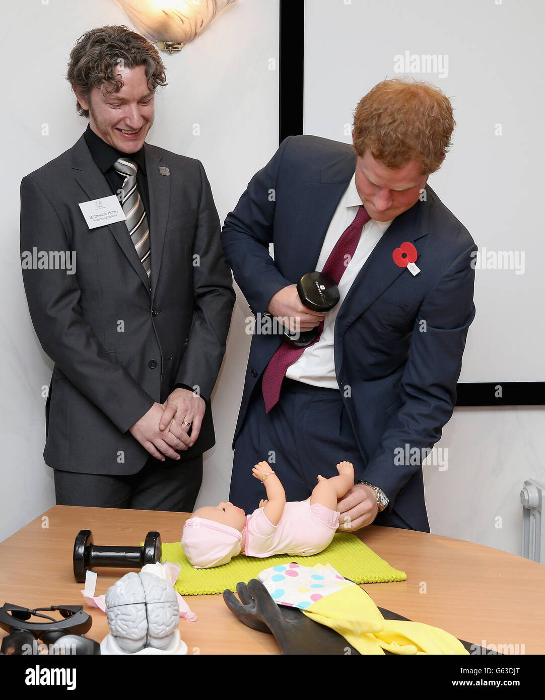Prince Harry is watched by brain injury survivor Dominic Hurley as he ...