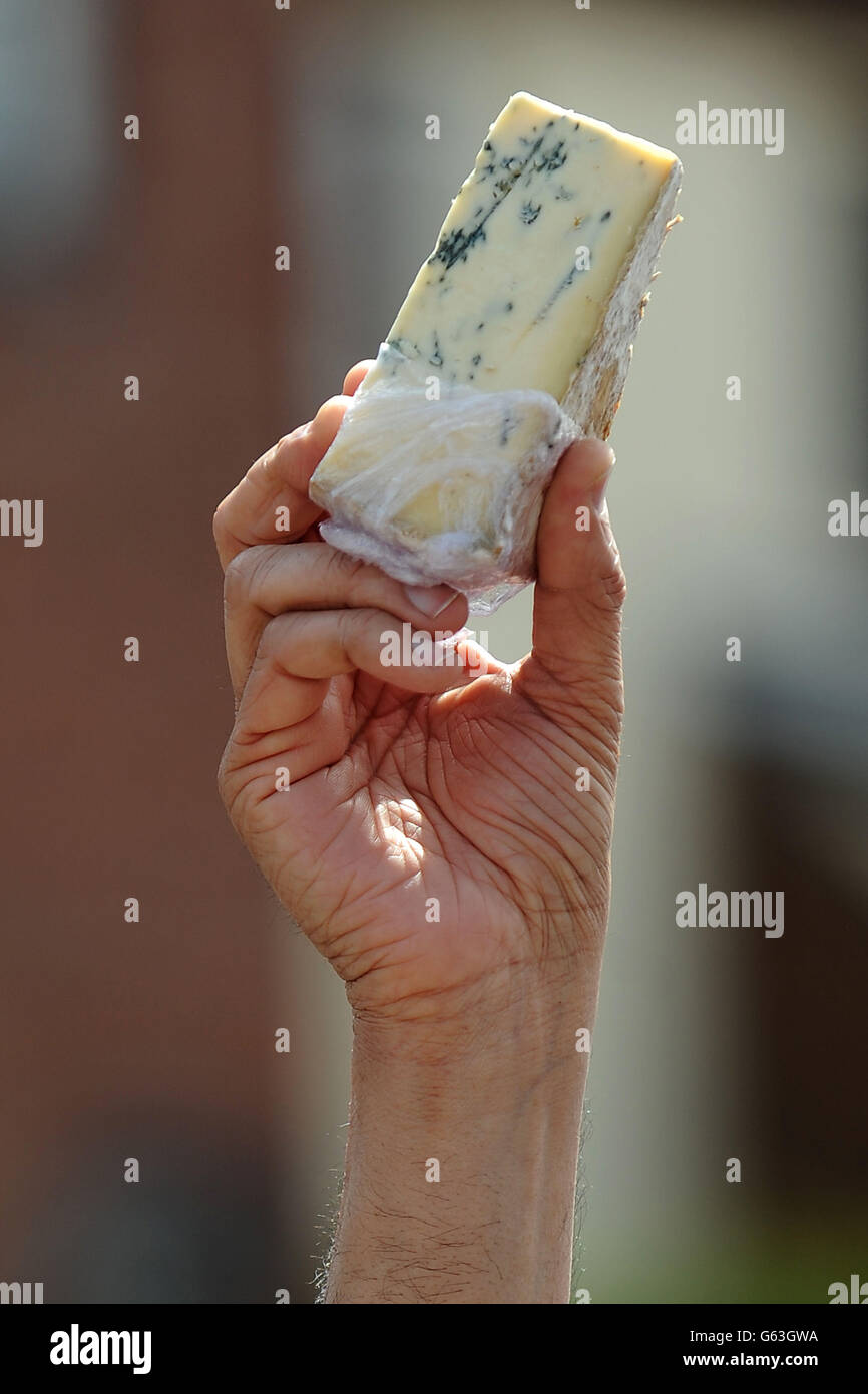 North West Cambridgeshire MP Shailesh Vara holds up a piece of Stilton ...