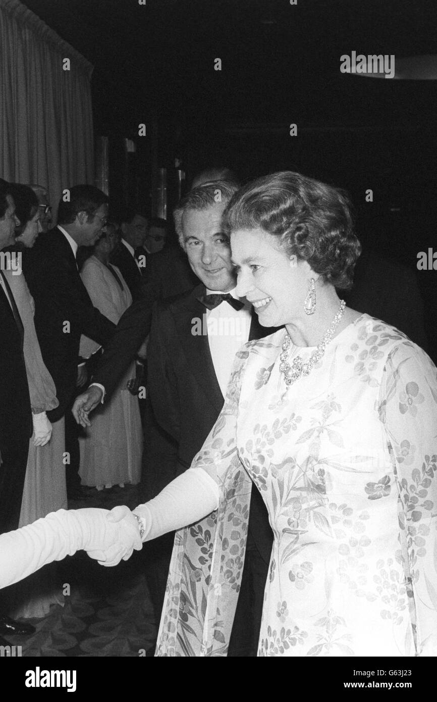 The Queen shakes hands with guests presented to her at the Empire ...