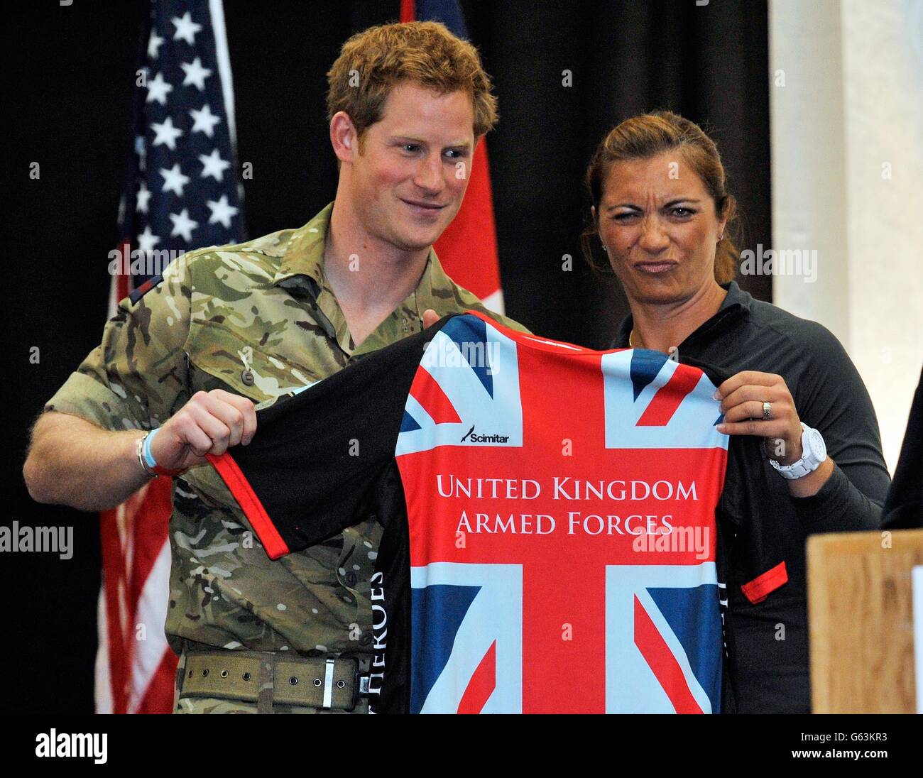 Prince Harry with Misty May Treanor as he is presented a t-shirt at a ...