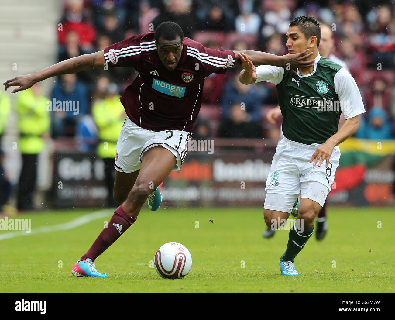 Hearts Michael Ngoo (left) challenges Hibernian's Jorge Carlos during ...
