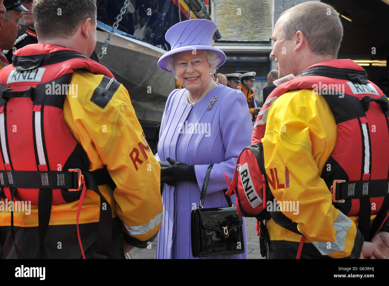 Queen Elizabeth II greets members of a lifeboat crew during a visit to ...