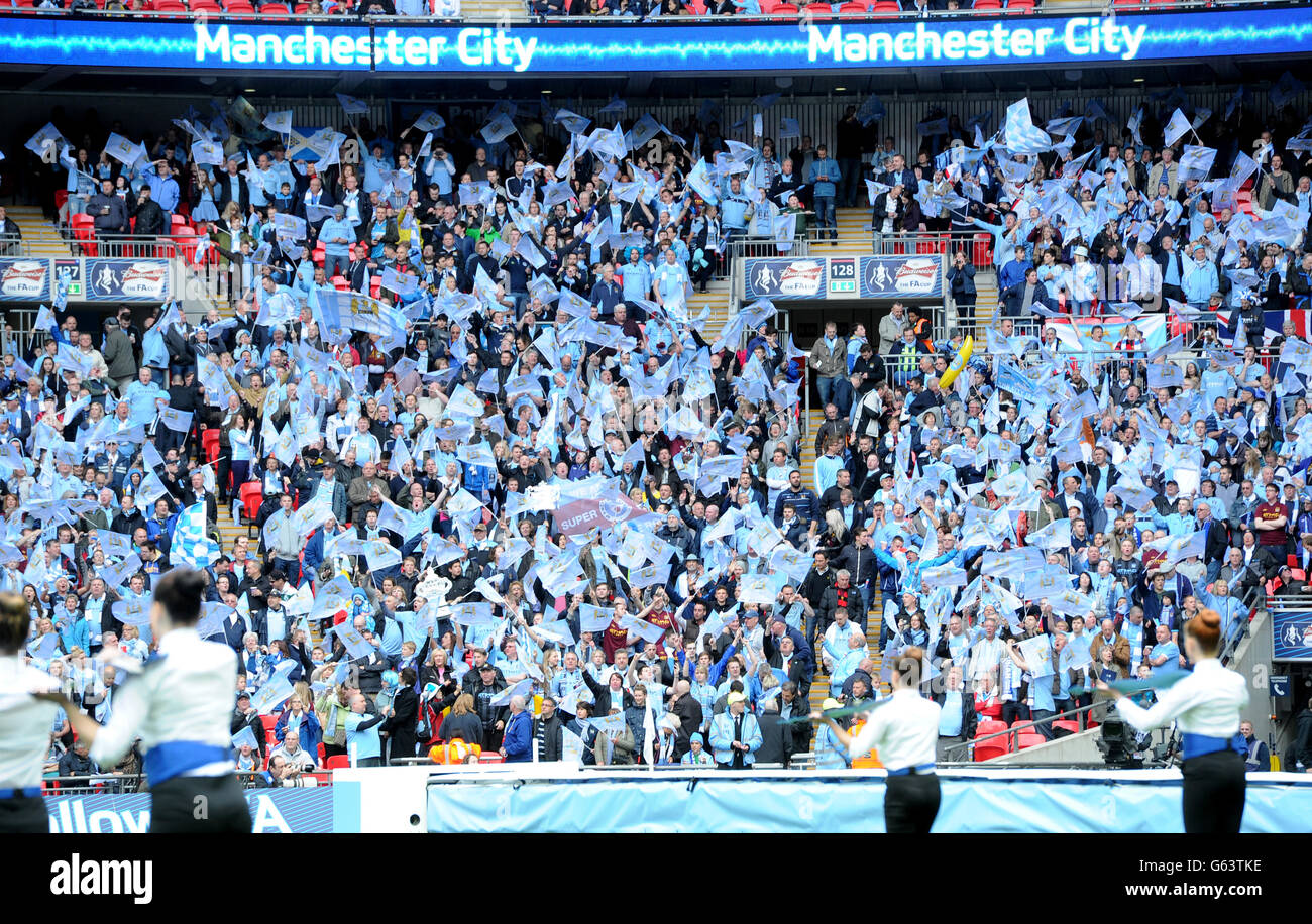 Manchester city fans wave flags in the stands hi-res stock photography ...