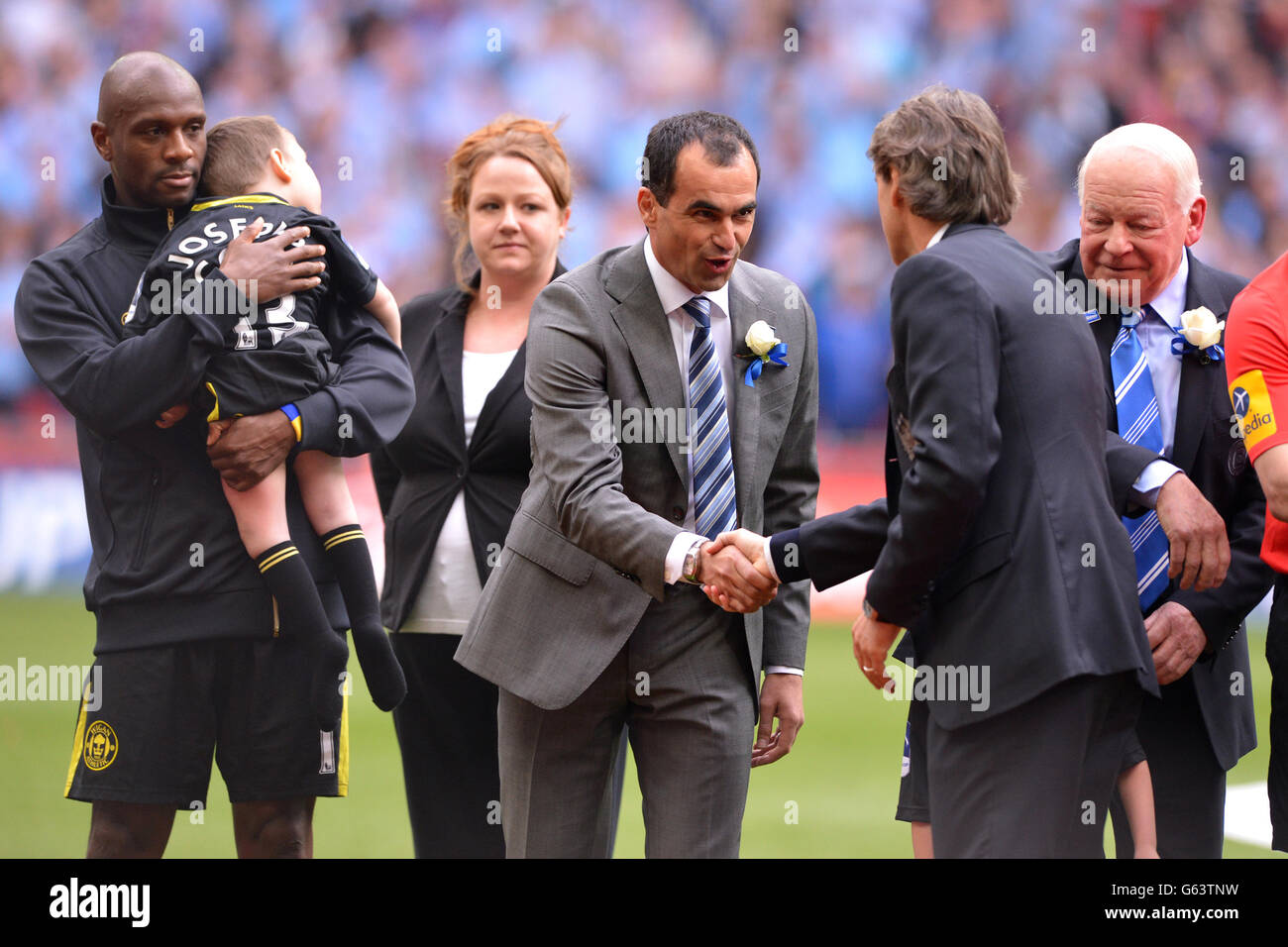 Manchester City manager Roberto Mancini (right) shakes hands with Wigan ...