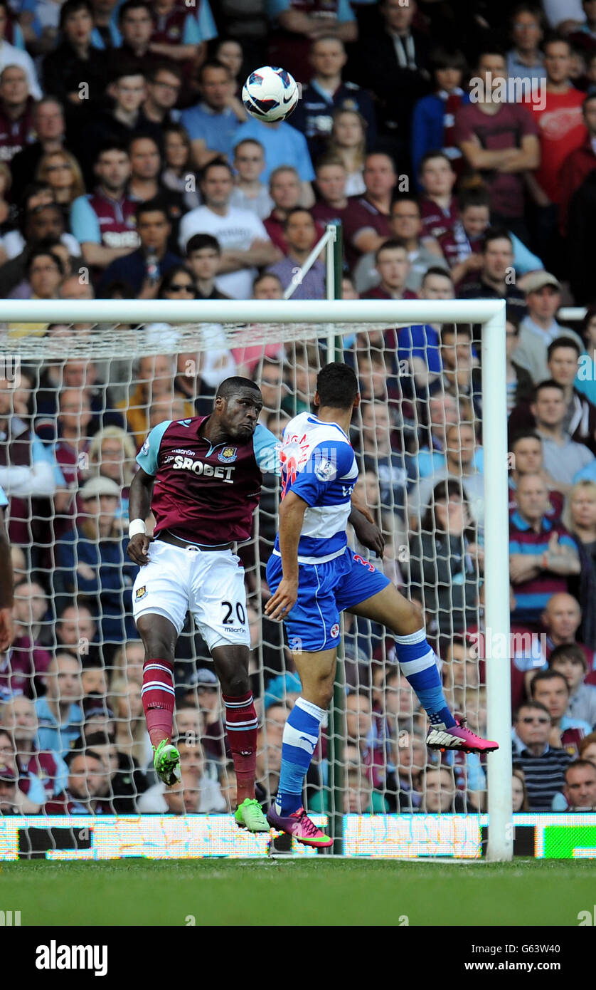 West Ham United's Guy Demel (left) and Reading's Nick Blackman jump for ...