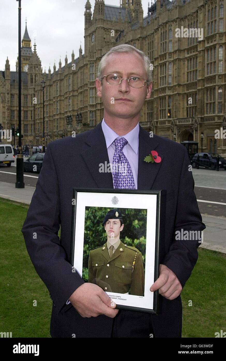 Geoff Gray from from Hackney, London holds a picture of his son, also ...