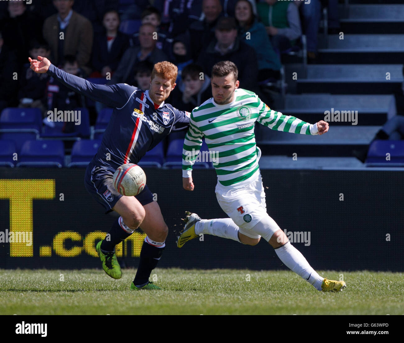 Ross County's Andre Hainault vies for the ball with Celtic's Tony Watt ...