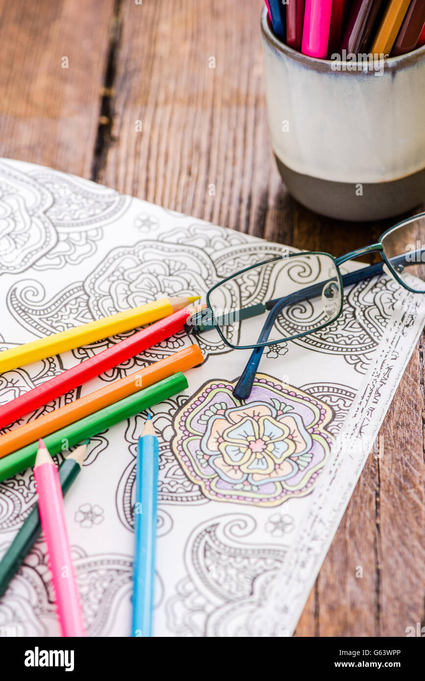 relaxing with adult coloring book, on wooden table Stock Photo - Alamy