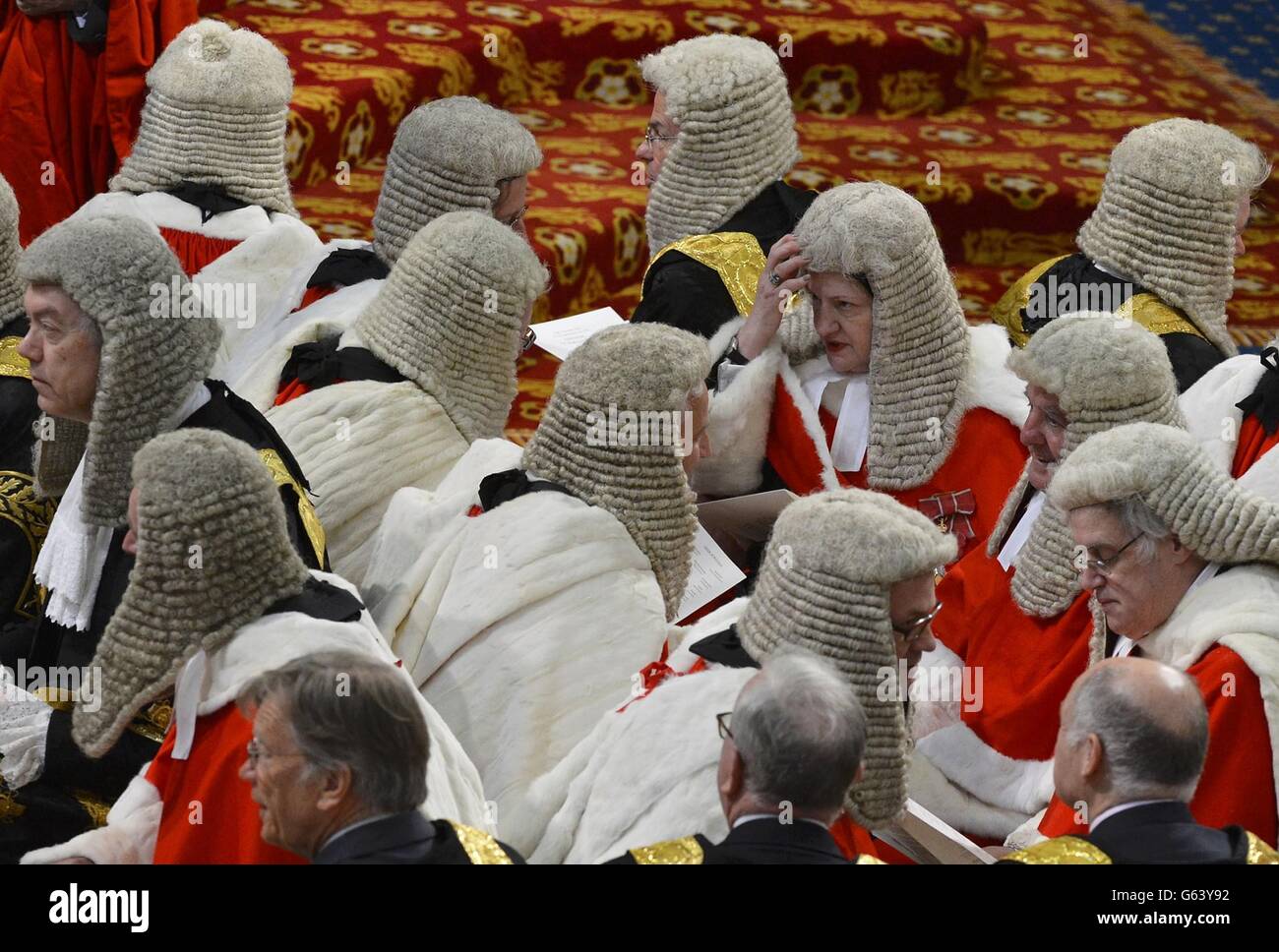 Judges sit in the House of Lords as they wait for the start of the ...