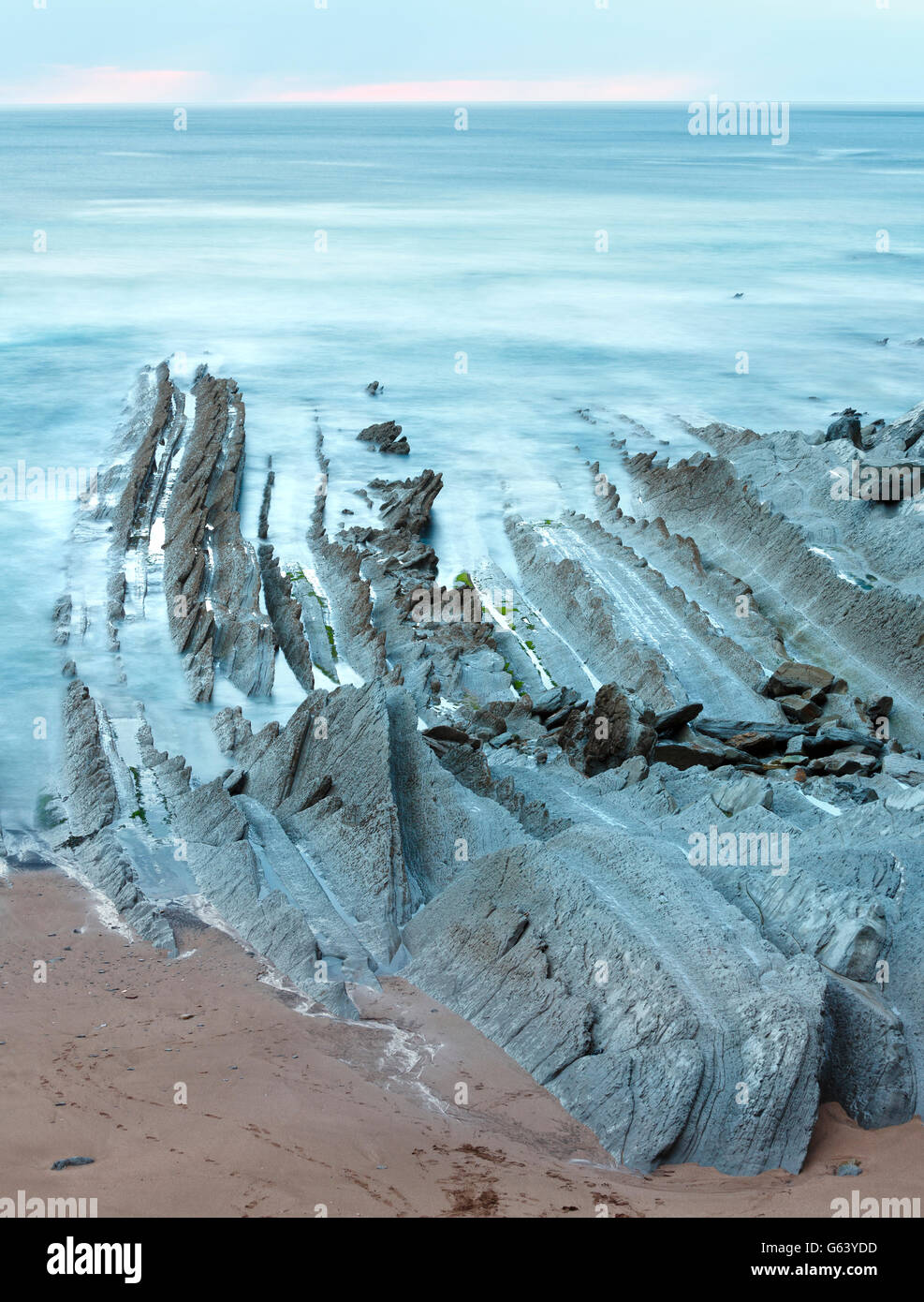 Twilight ocean coast with ribbed stratiform rock formations. (Atlantic ...