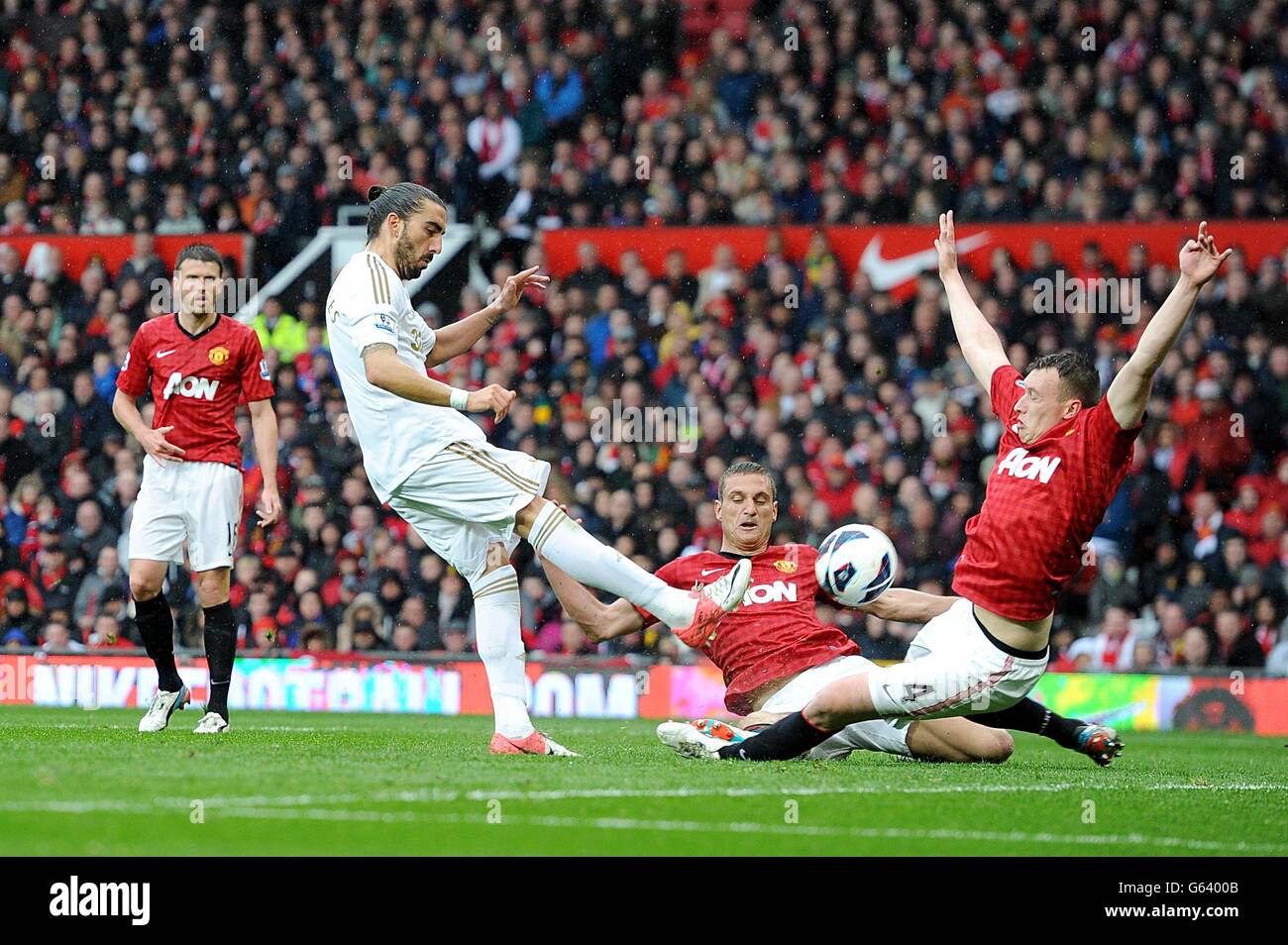 Manchester United's Nemanja Vidic (second right) and Phil Jones (right ...