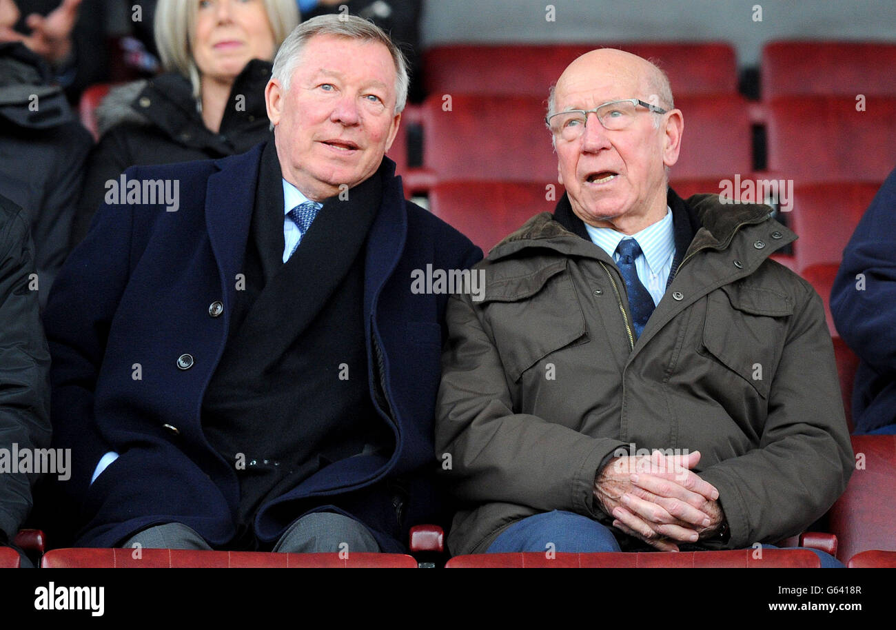 Manchester United manager Sir Alex Ferguson takes his seat next to Sir ...