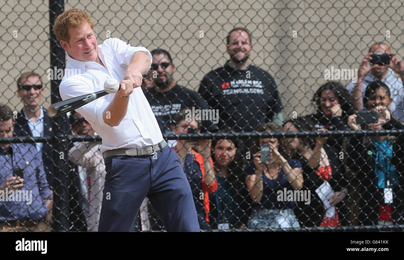Prince Harry hits a baseball as he meets a number of young people ...