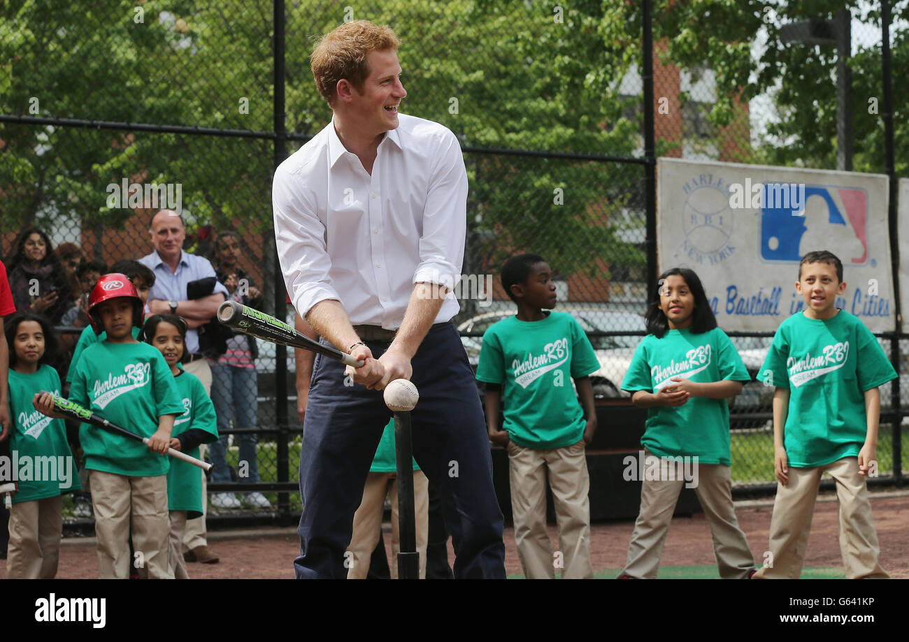Prince Harry prepares to hit a baseball as he meets a number of young ...