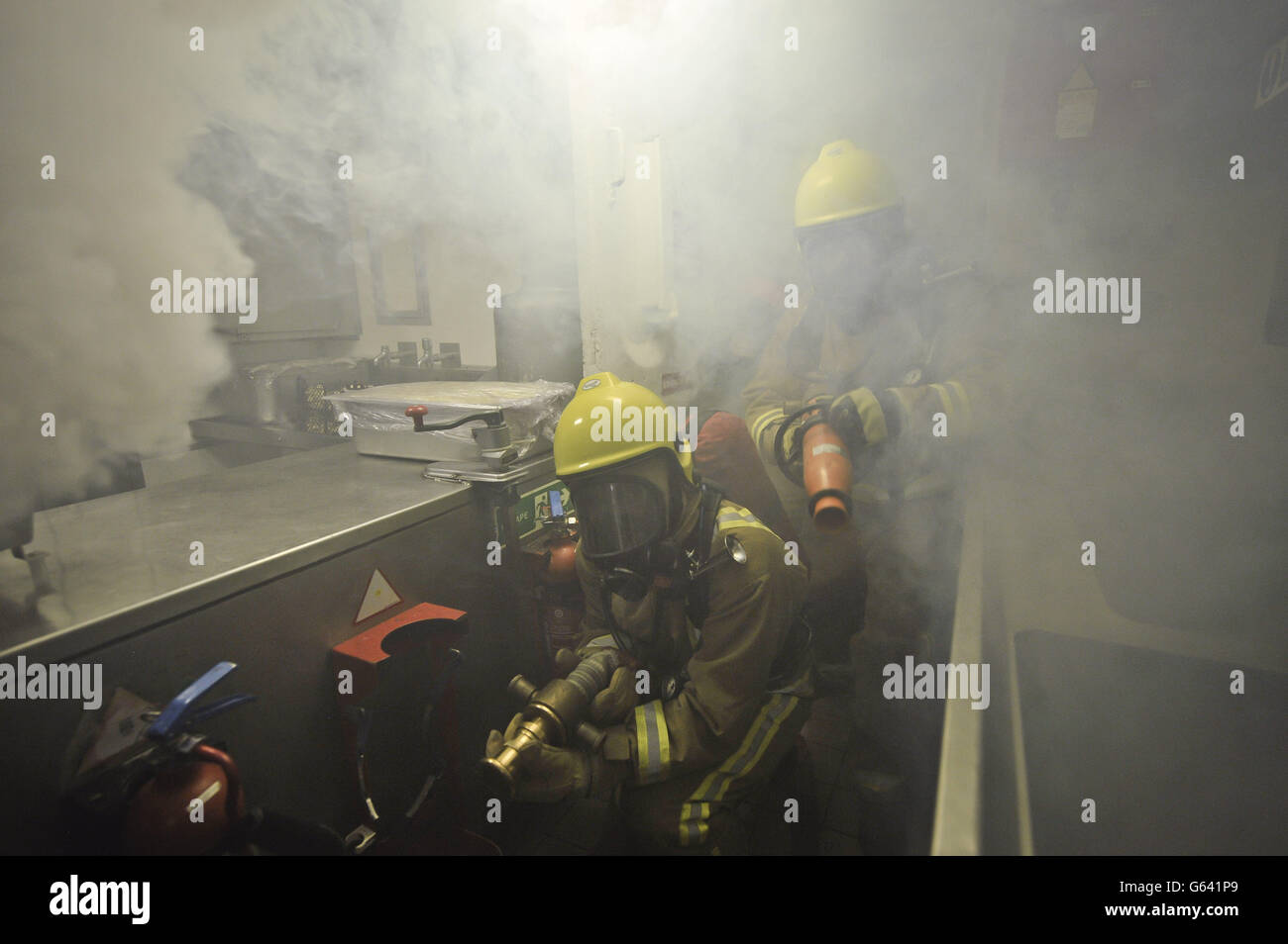 Royal Navy personnel take part in a firefighting exercise as part of ...