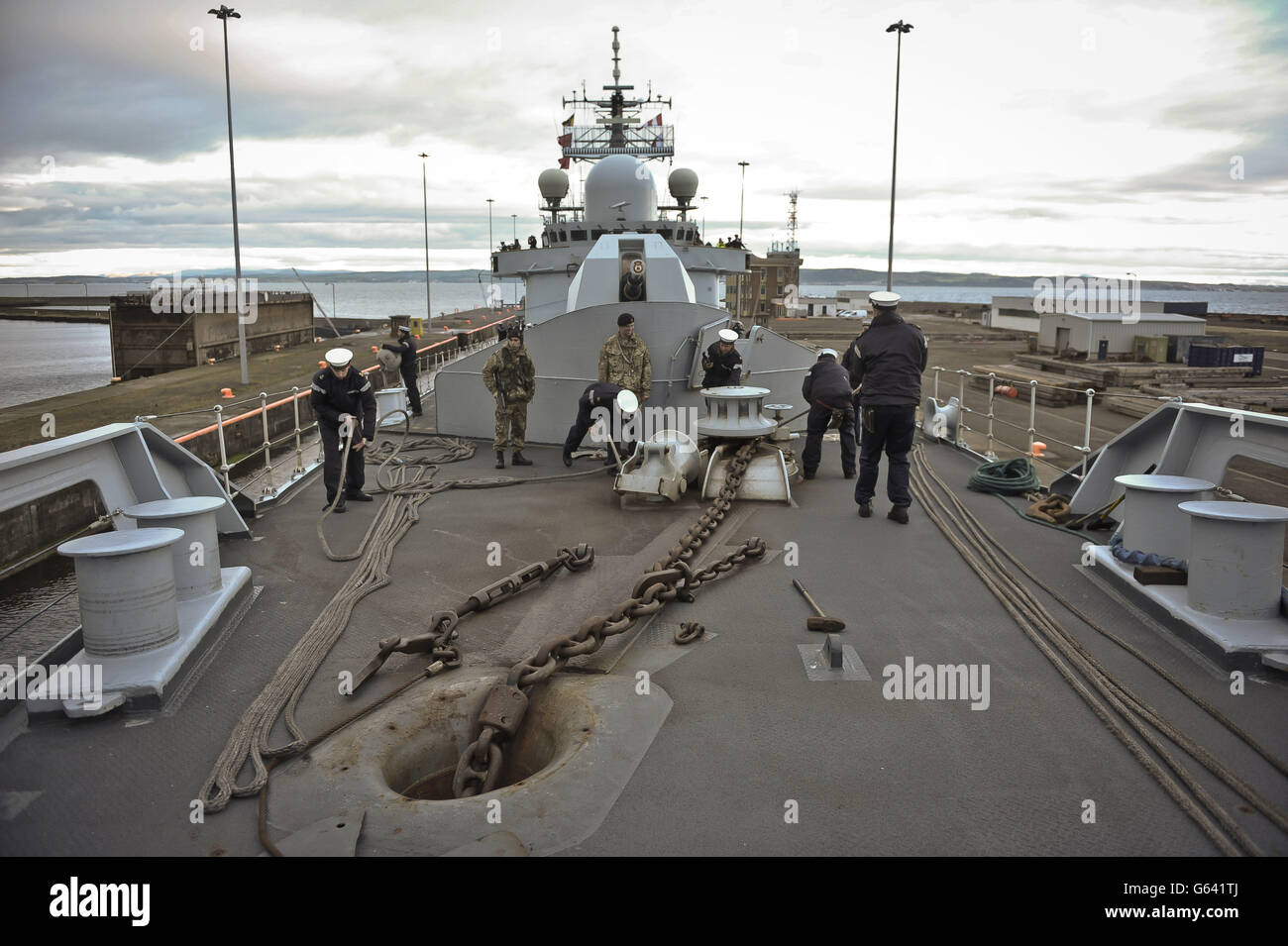 The crew of HMS Edinburgh ready ropes for berthing in Leith docks ...