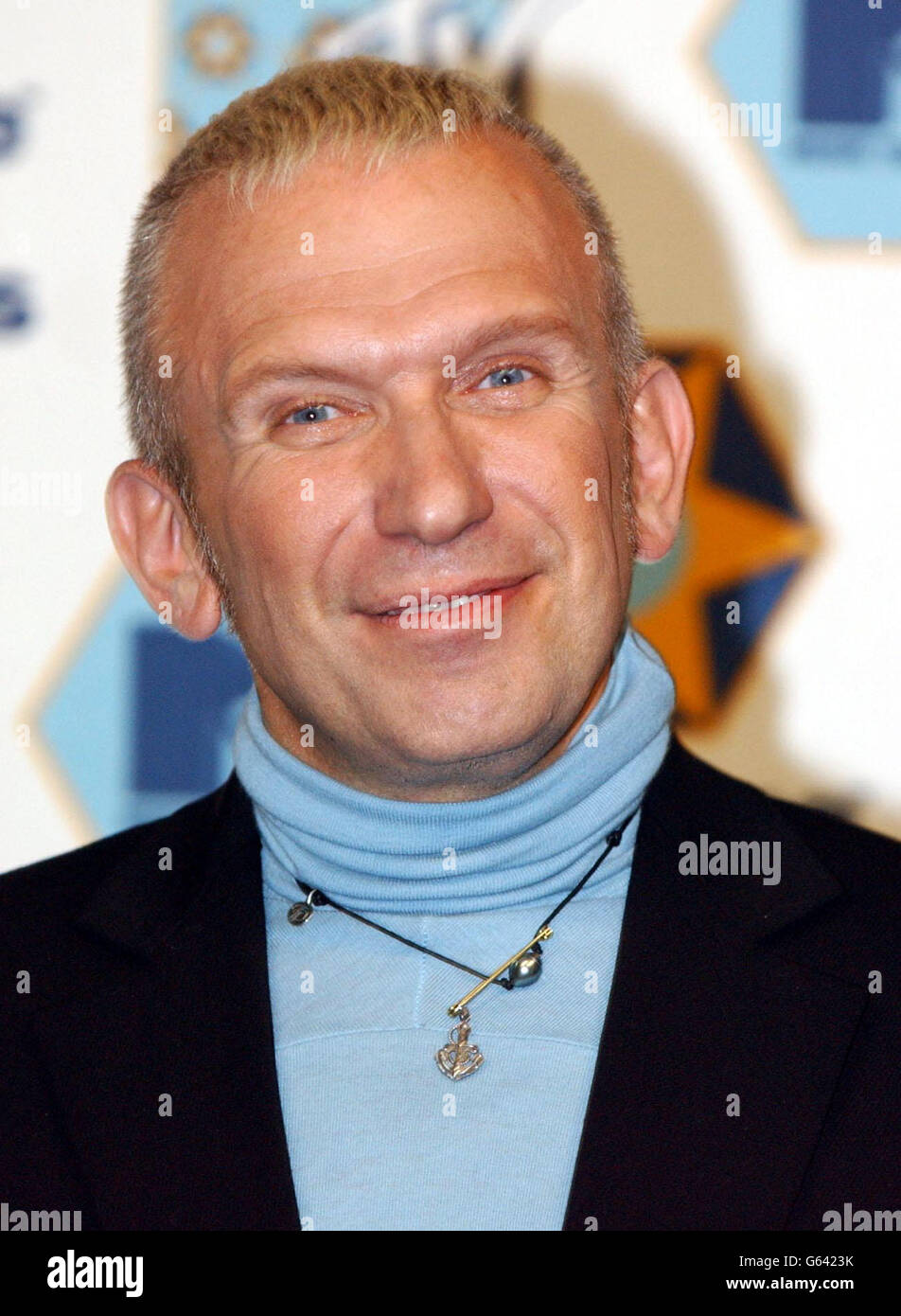 Celebrity head shoulder blue polo neck top necklace pendant smiling hi ...