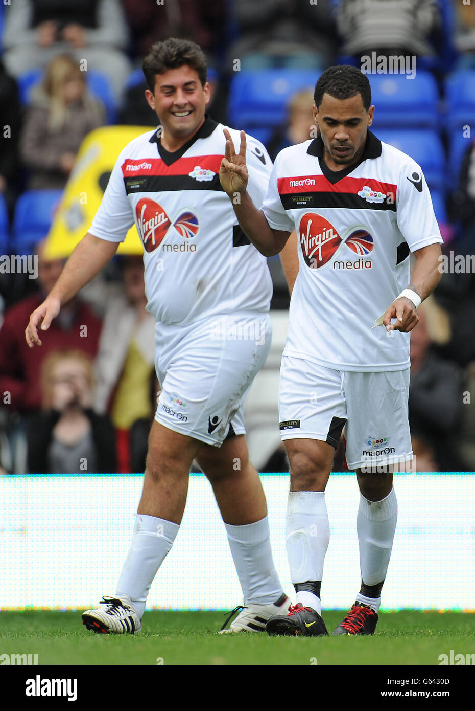 Rapper MC Harvey (right) celebrates a goal with reality tv star James ...
