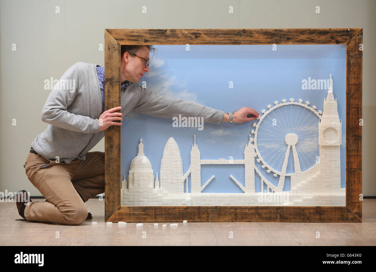 . Artist Chris Naylor adds the finishing touches to a model landscape ...