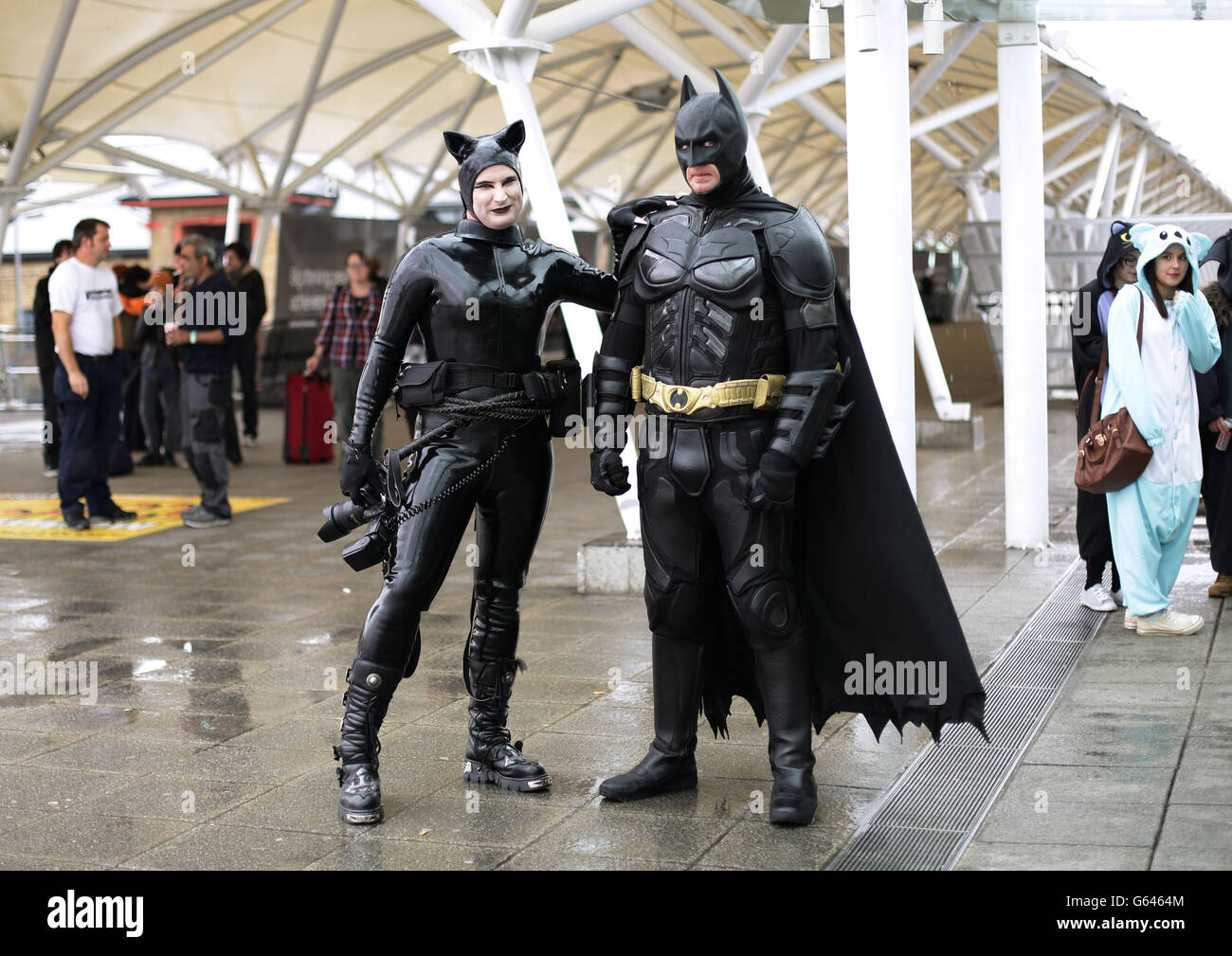 People in costume queue up at an ATM machine whilst attending the MCM ...