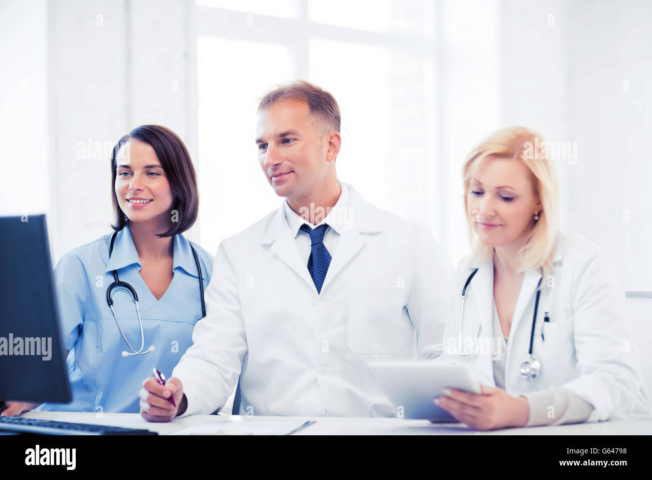 doctors looking at computer on meeting Stock Photo - Alamy