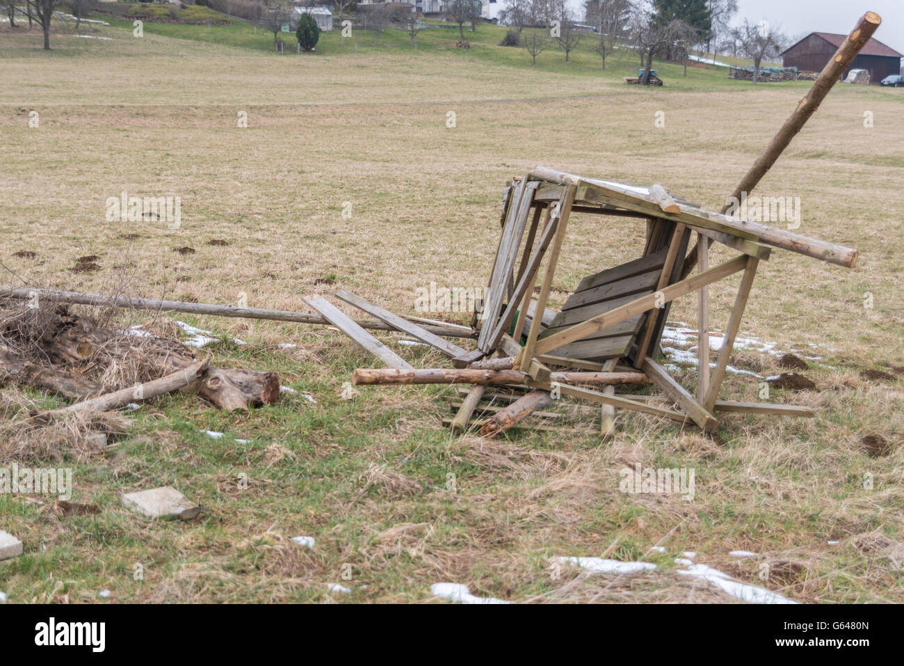 Destroyed raised hide on a meadow in the winter Stock Photo - Alamy