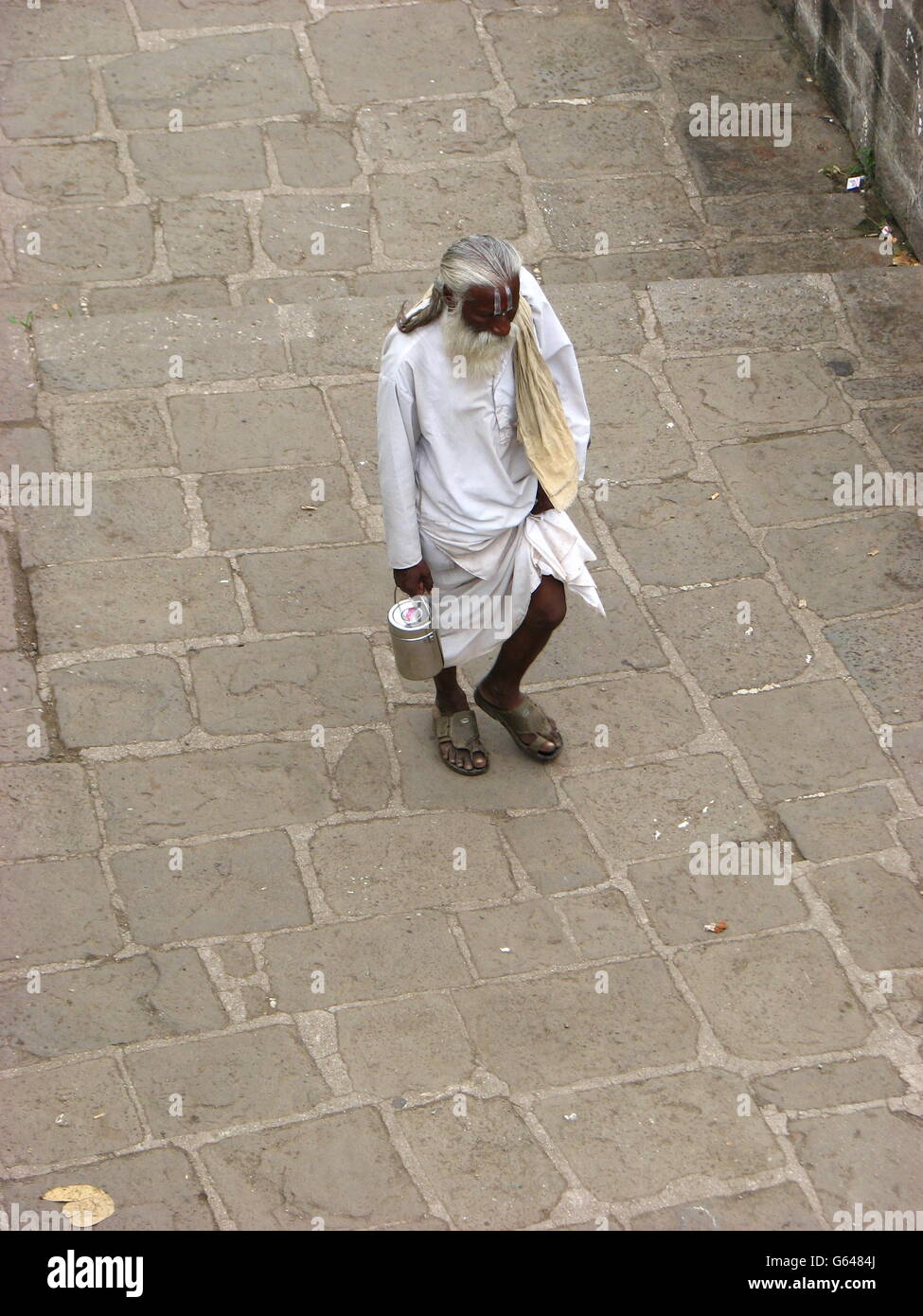 An old pilgriming climbing up ancient fort steps in India Stock Photo ...