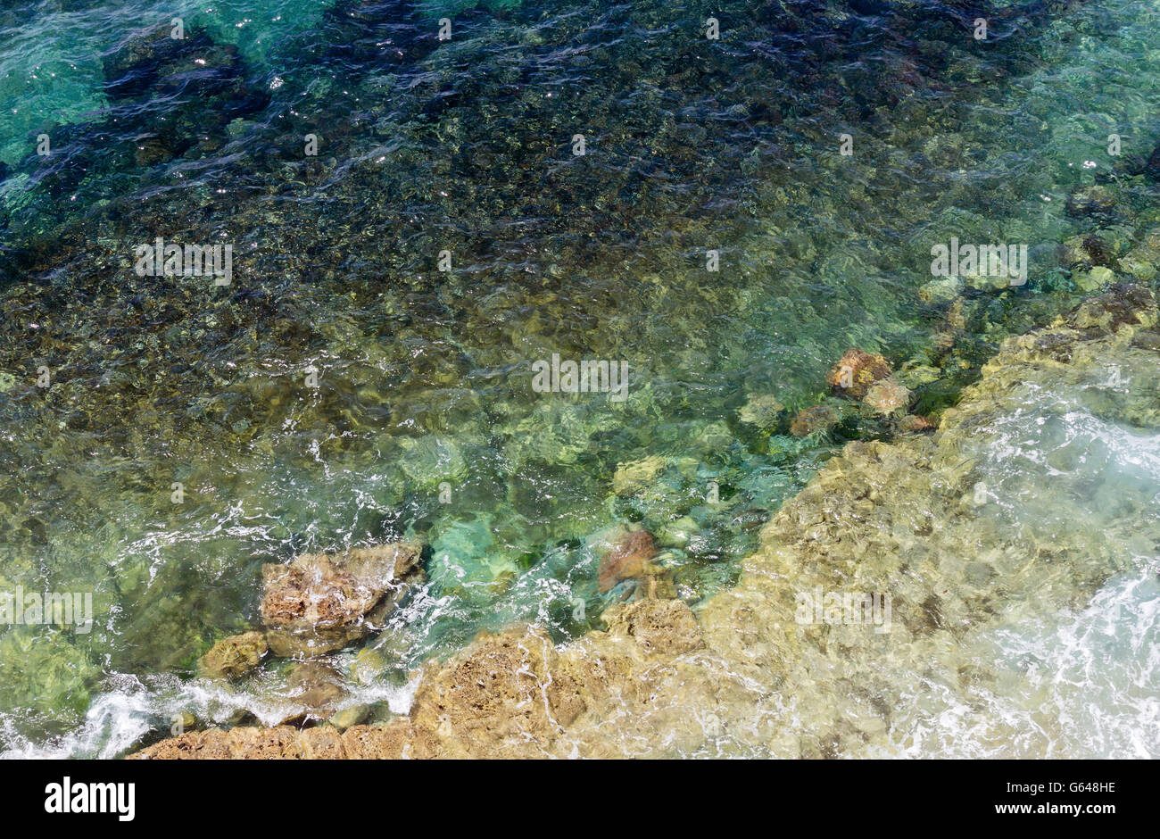 Limpid sea water surface with stones on bottom. View from above. Nature ...