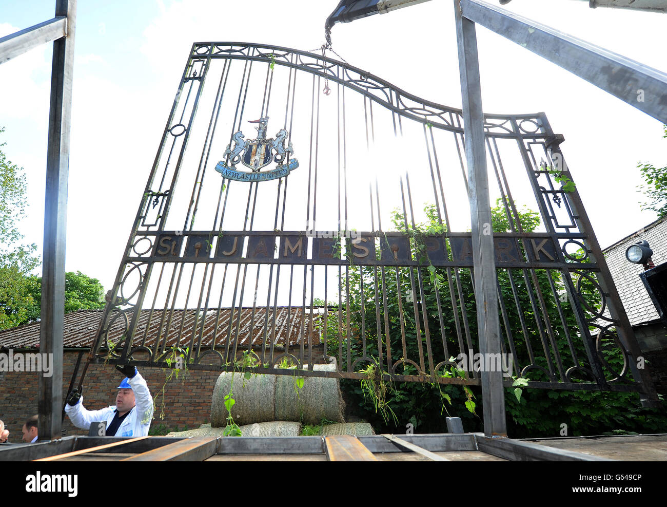 A worker moves one of the former gates of St. James' Park, the home of ...