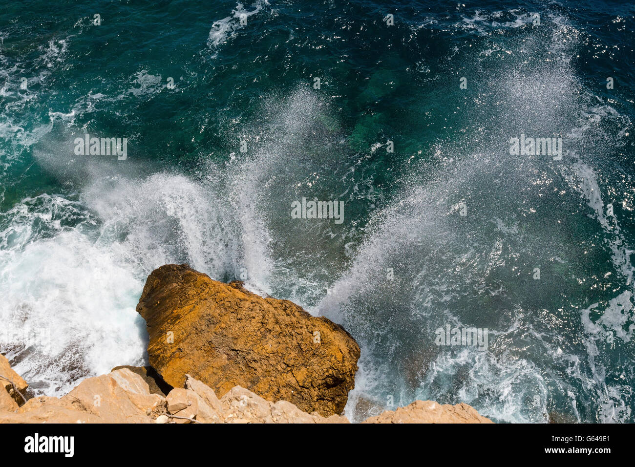 Waves breaking on rocky coast. View from above Stock Photo - Alamy