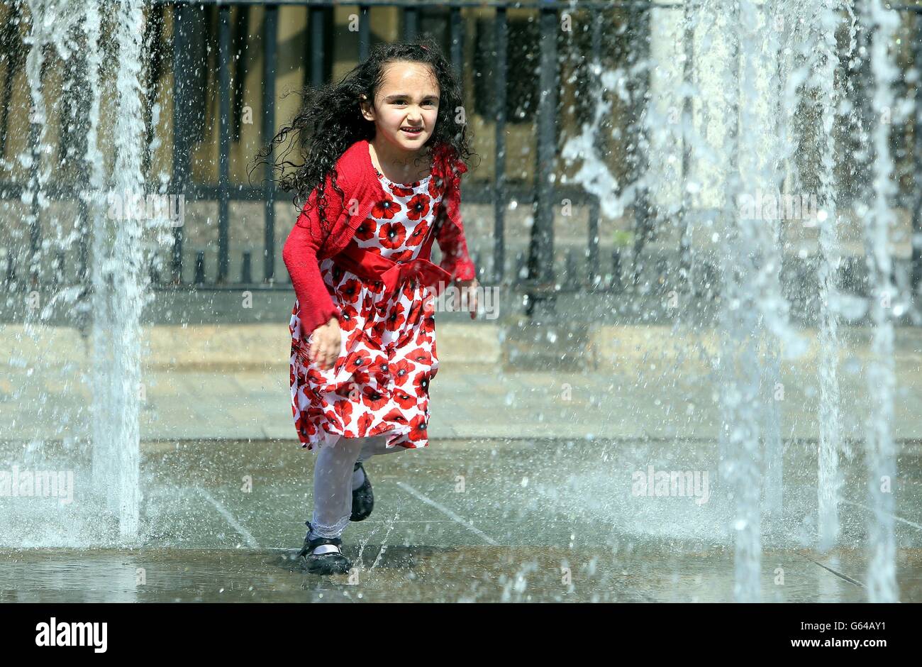 Emma Lynch, six, plays in the water feature at Custom House Square in ...