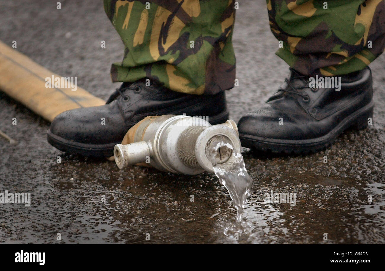A soldier stops the water flow as he practises using equipment at the ...