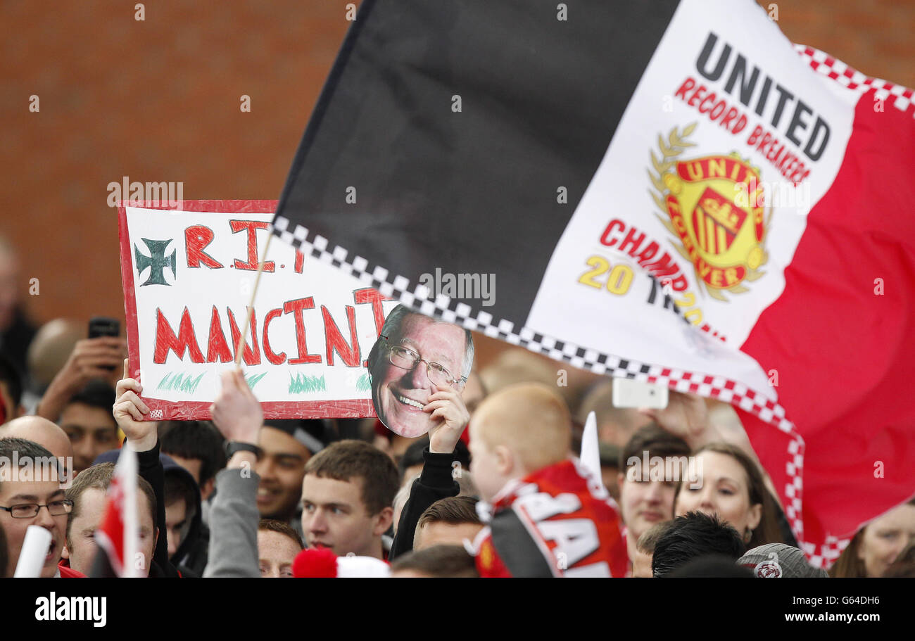 A Manchester United fan with a banner taunting rivals Manchester City ...