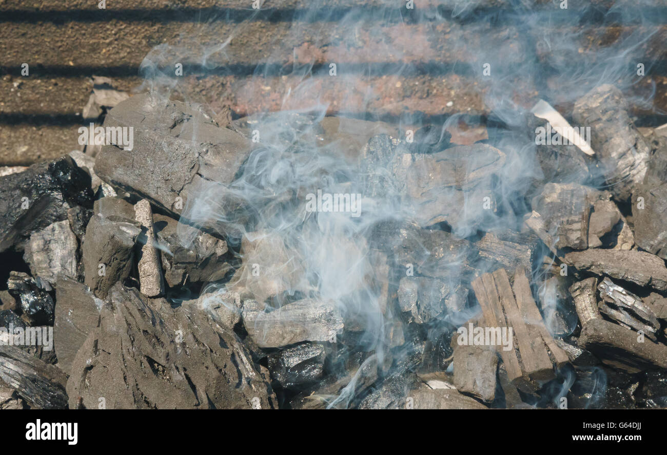 Glowing coals in a barbeque grill coal fire smoke Stock Photo - Alamy