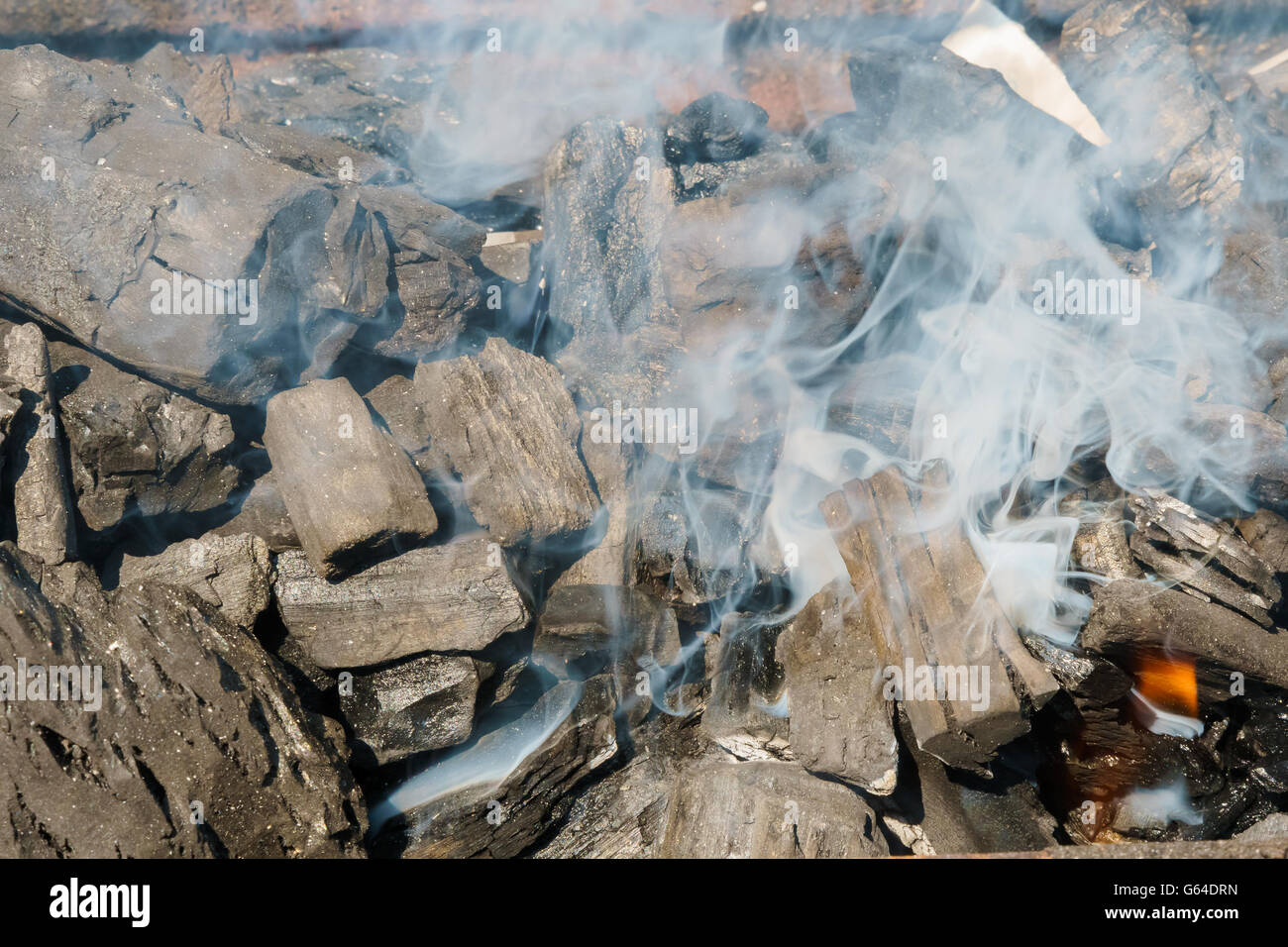 Glowing coals in a barbeque grill coal fire smoke Stock Photo - Alamy