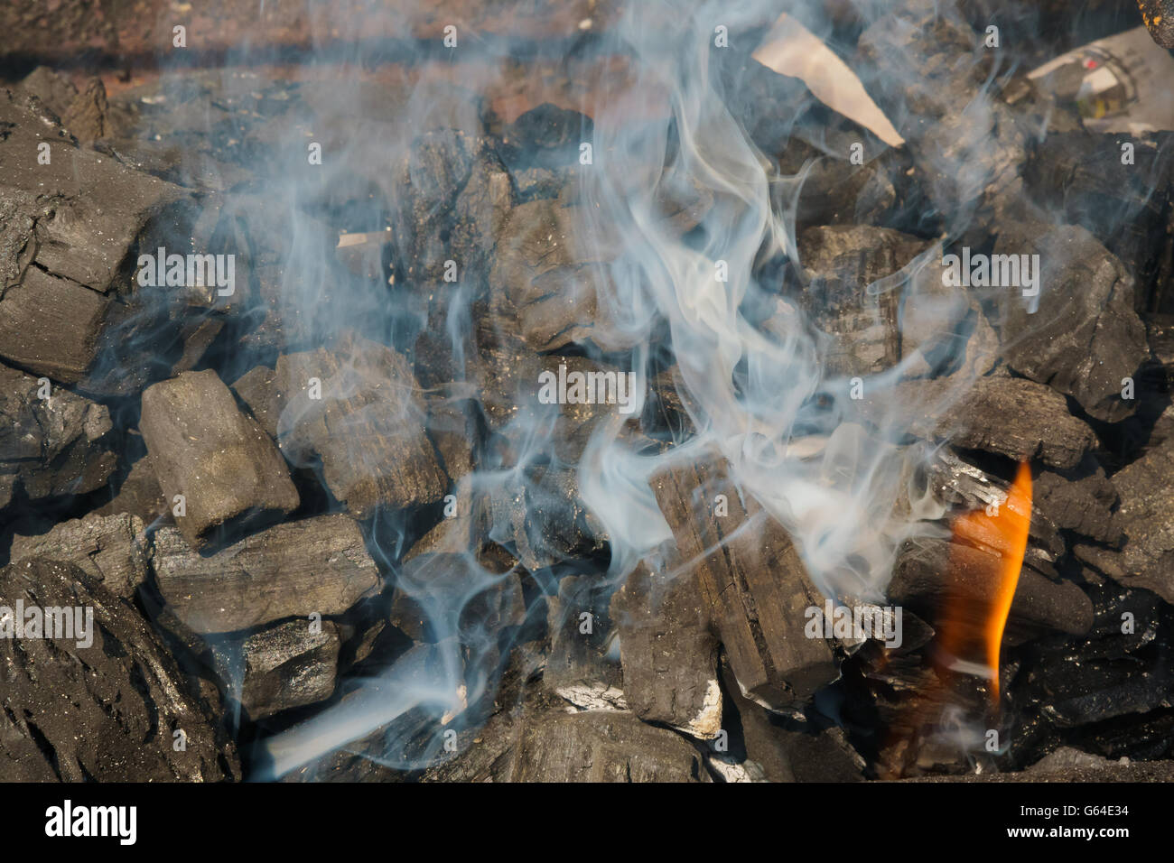 Glowing coals in a barbeque grill coal fire smoke Stock Photo - Alamy