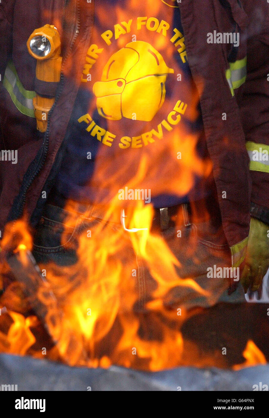 A fire fighter stands in front of a brazier at Euston Fire Station ...