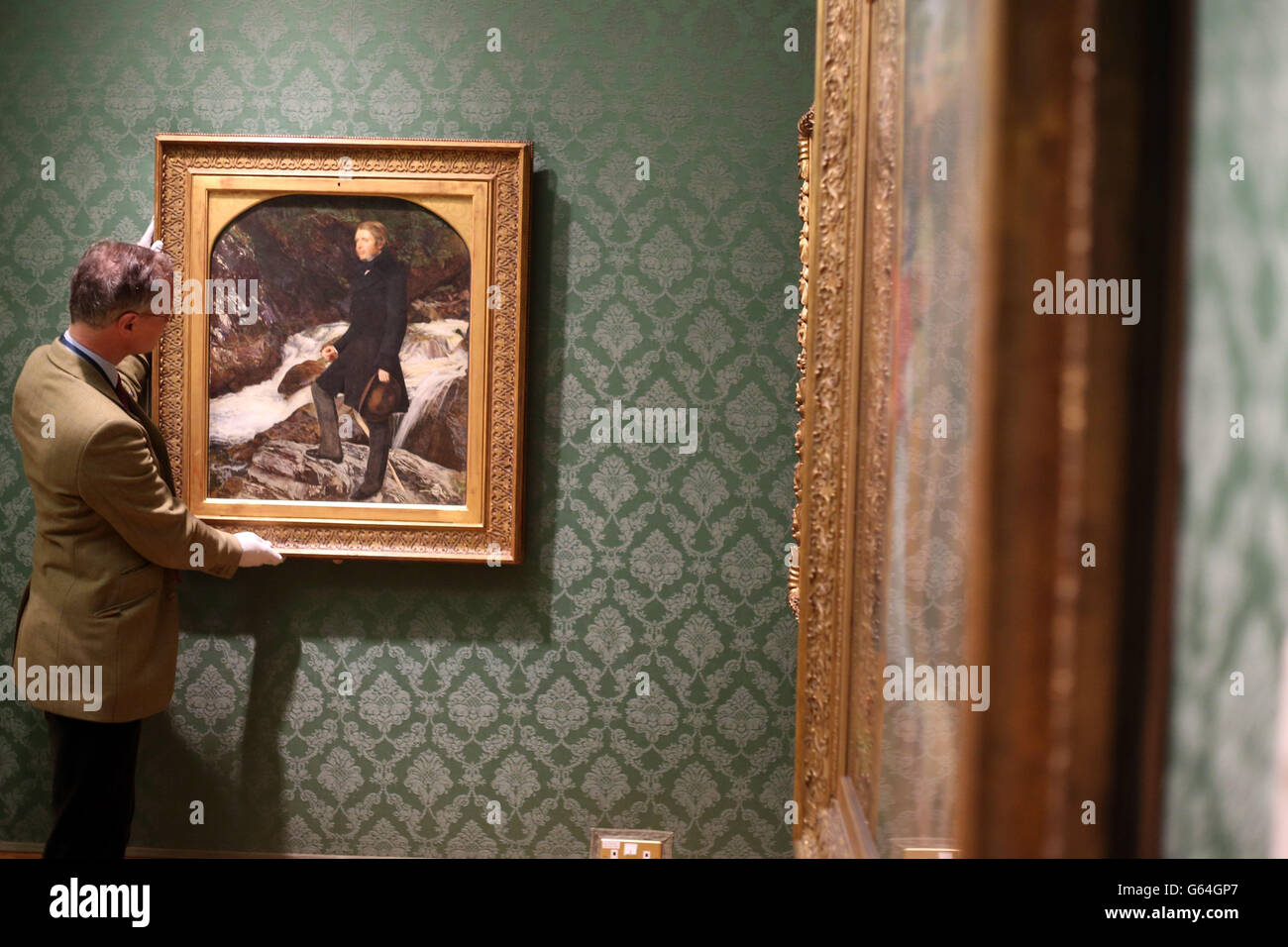 Colin Harrison who is Senior Curator of European Arts adjusts a ...