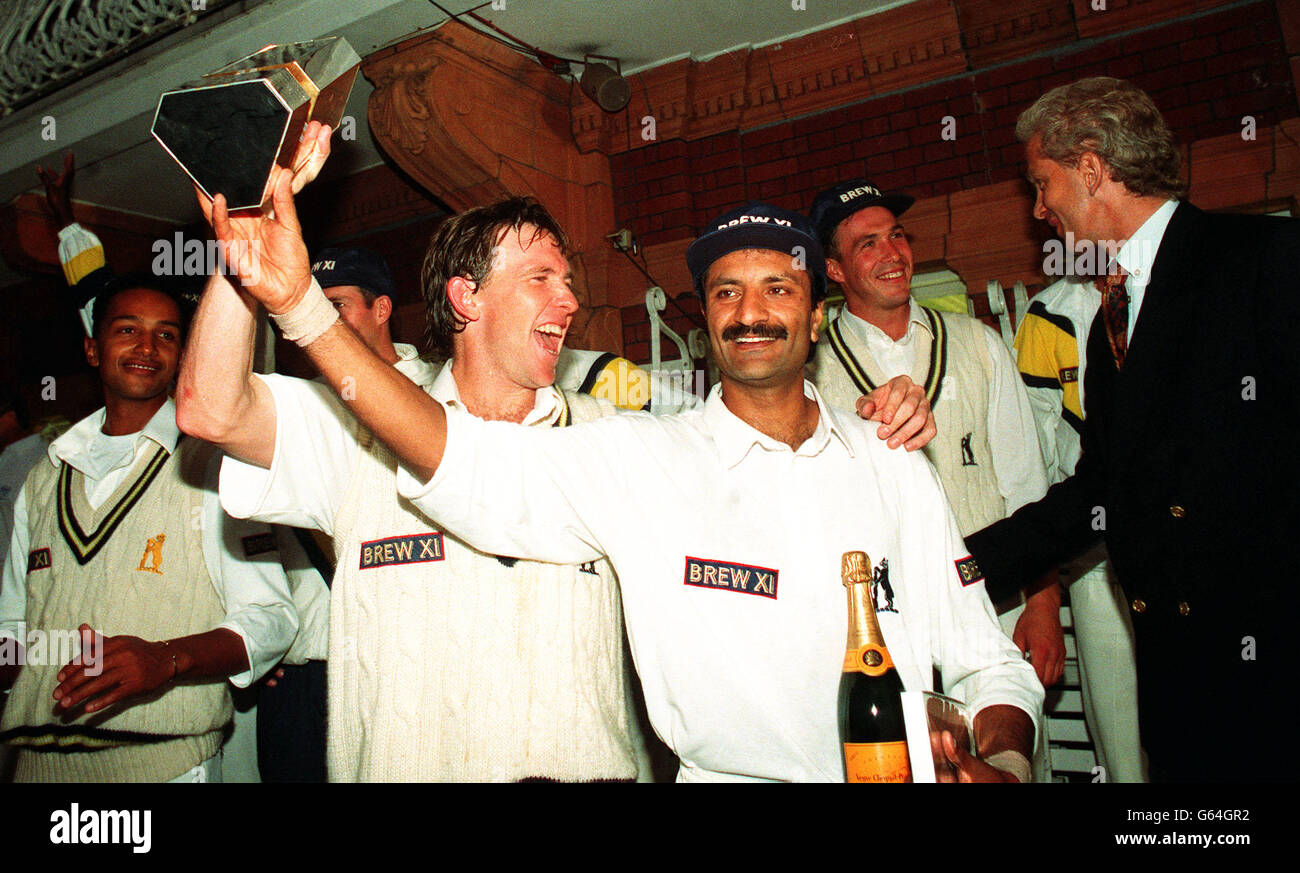 Holds the natwest trophy with his team captain dermot reeve hi-res ...