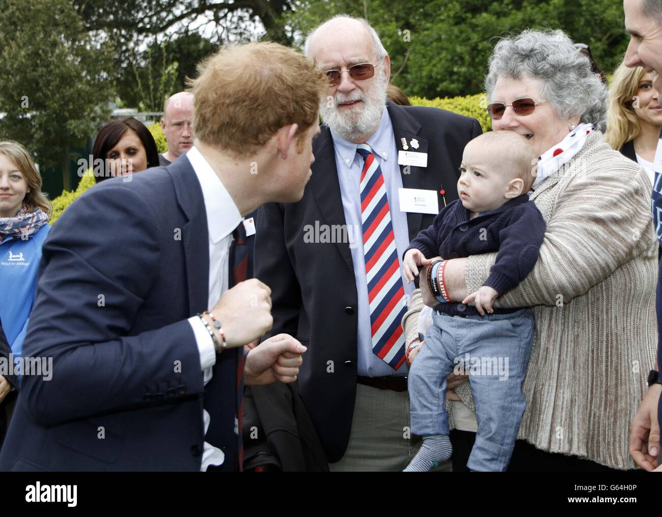 Prince Harry with a baby at Tedworth House, Tidworth, Wiltshire, where ...