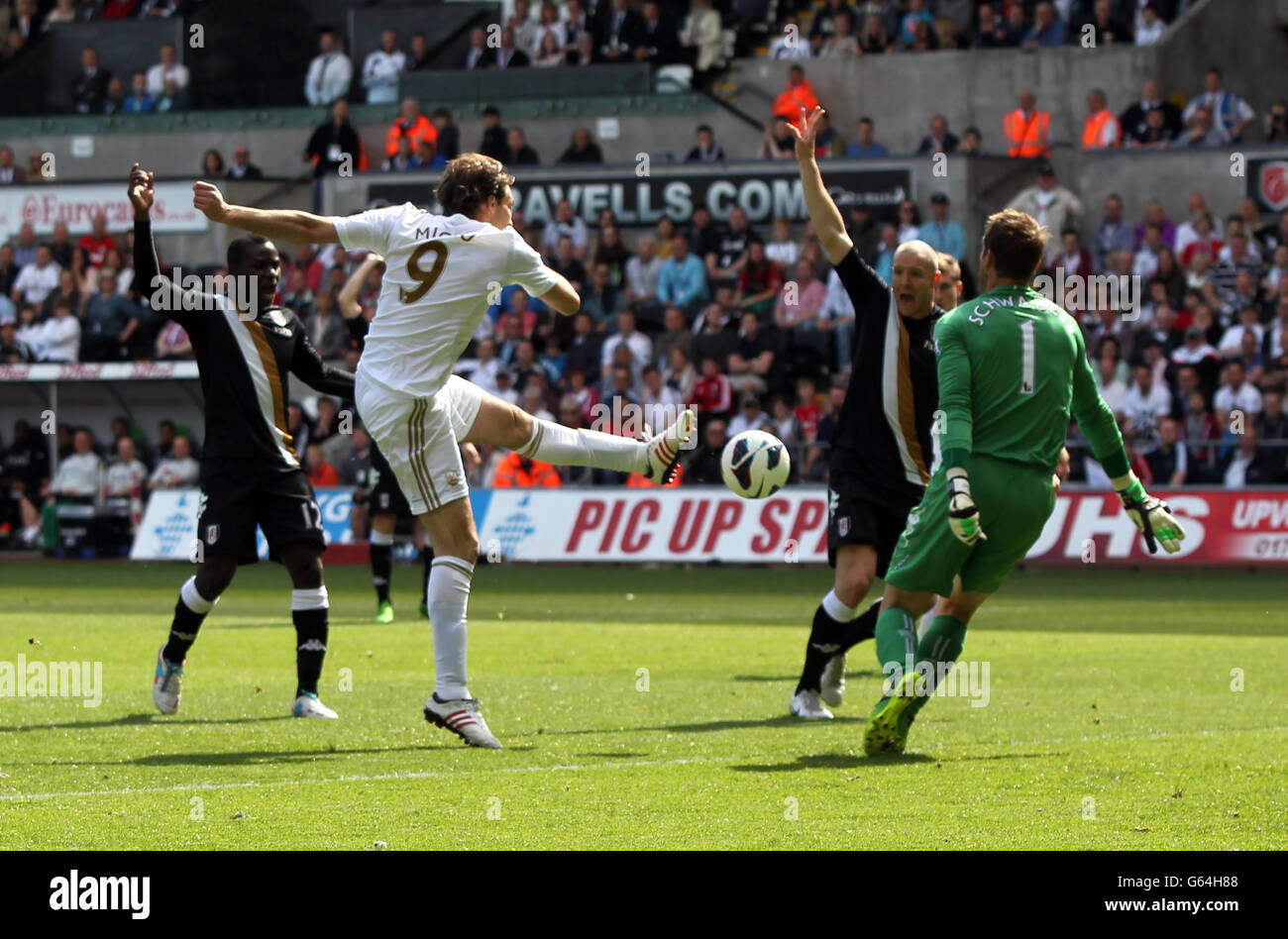 Fulham goalkeeper Mark Schwarzer (right) makes a save during the ...