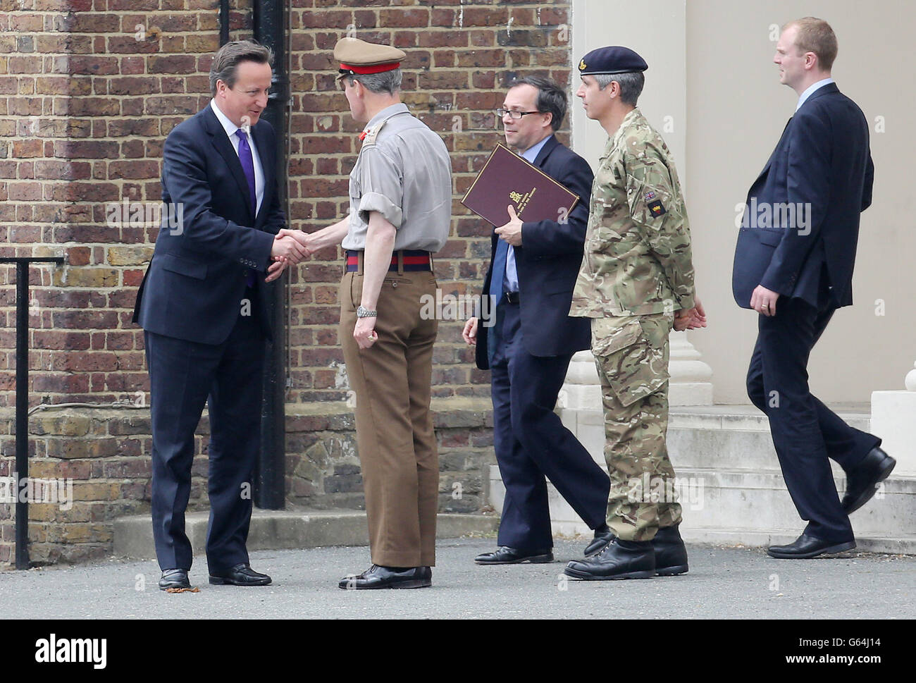 Prime Minister David Cameron leaves Woolwich Barracks in London ...
